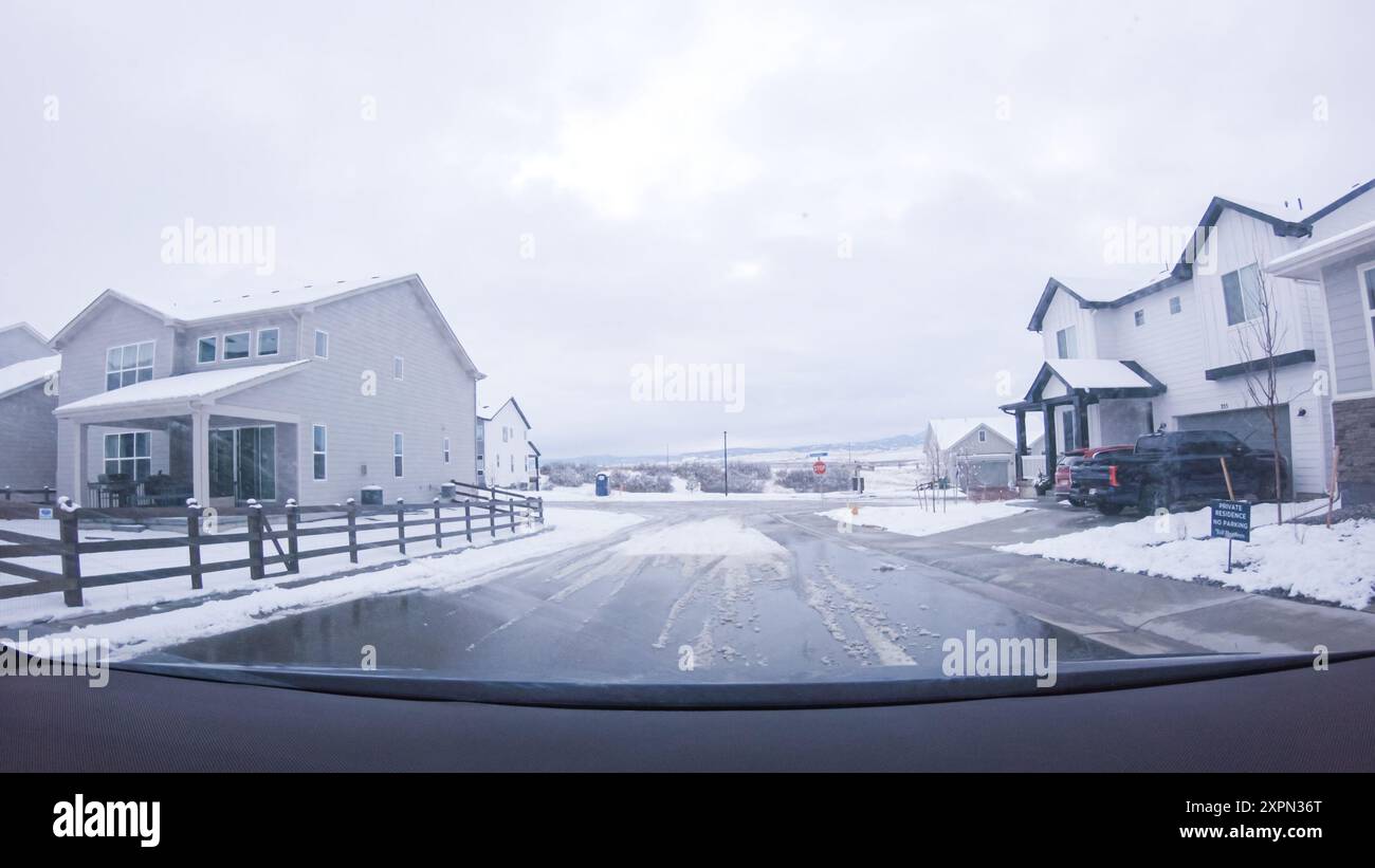Navigating Through a Snowy Suburban Neighborhood at Dawn Stock Photo ...