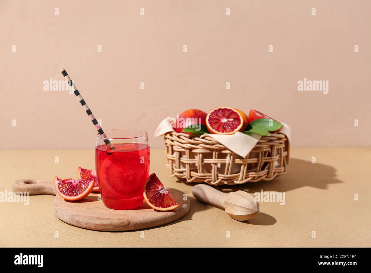 Glass of tasty blood orange lemonade on beige background Stock Photo ...