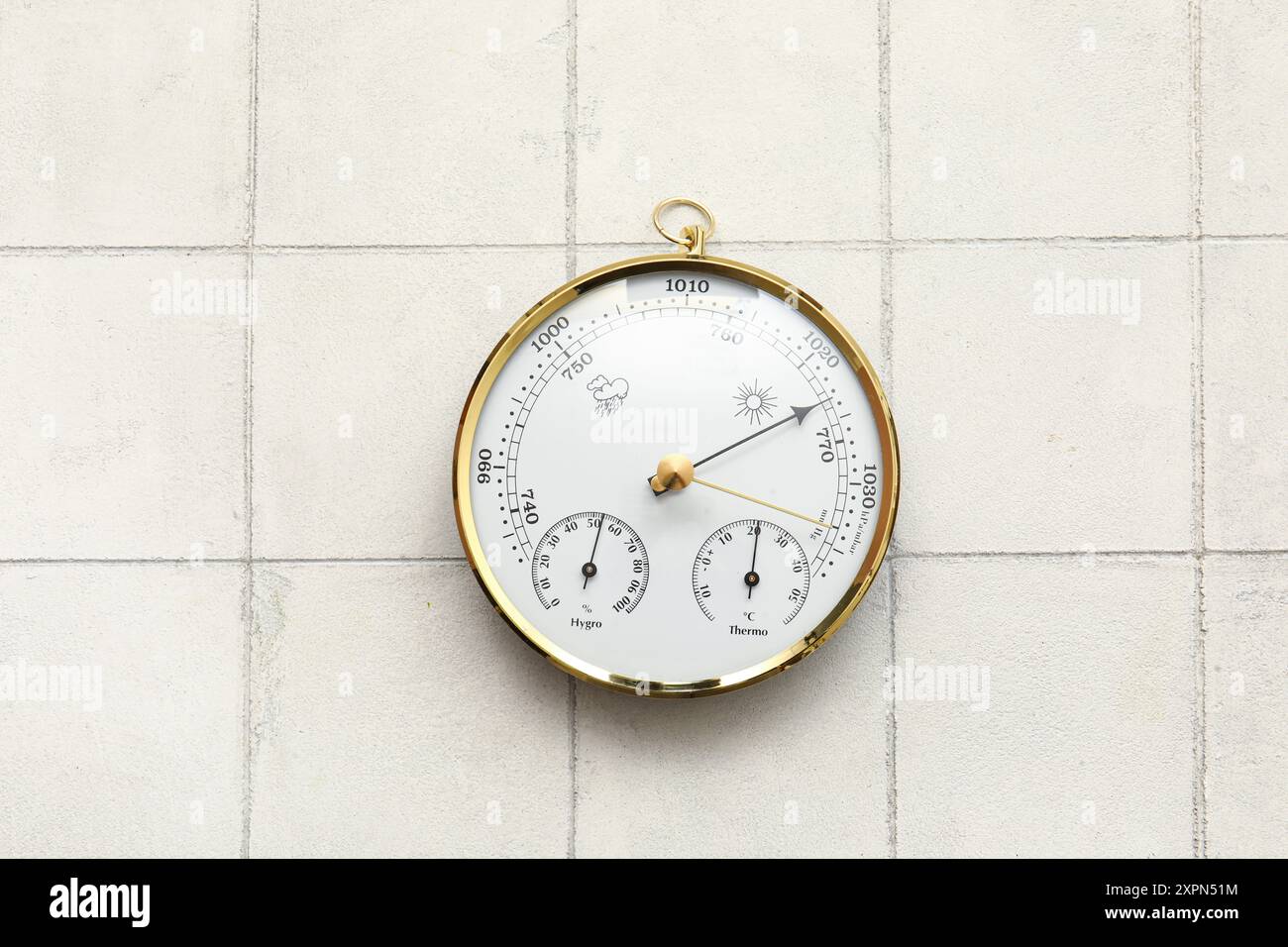 Aneroid barometer on white tiled background Stock Photo - Alamy
