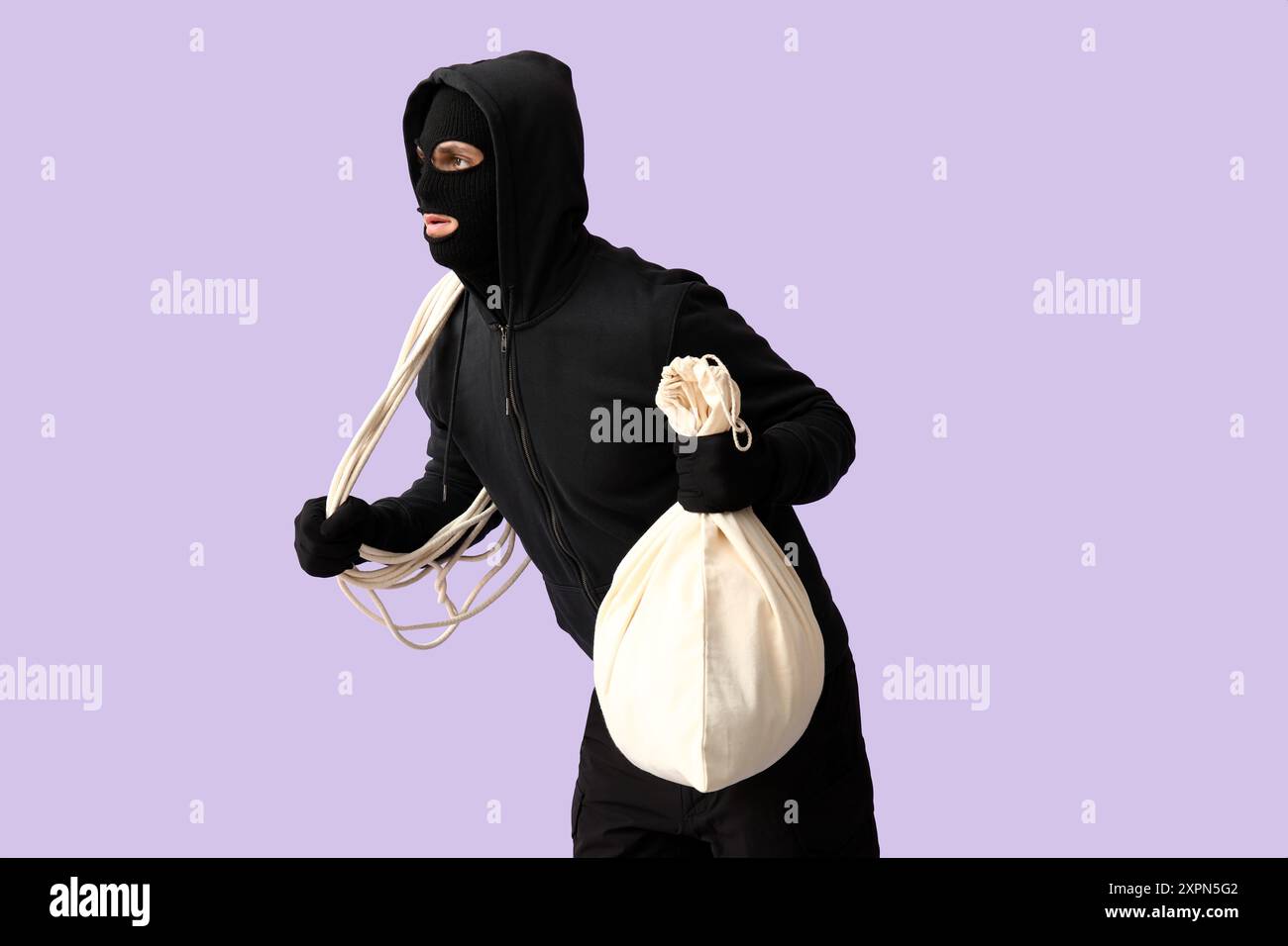 Male thief with bag and rope on lilac background Stock Photo - Alamy