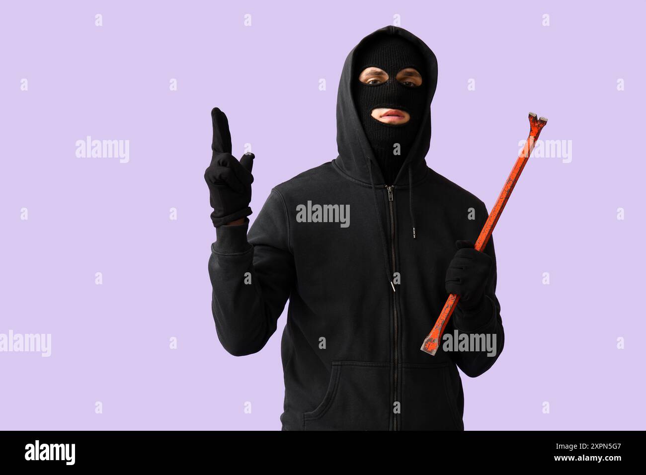 Male thief with crowbar showing gun gesture on lilac background Stock ...