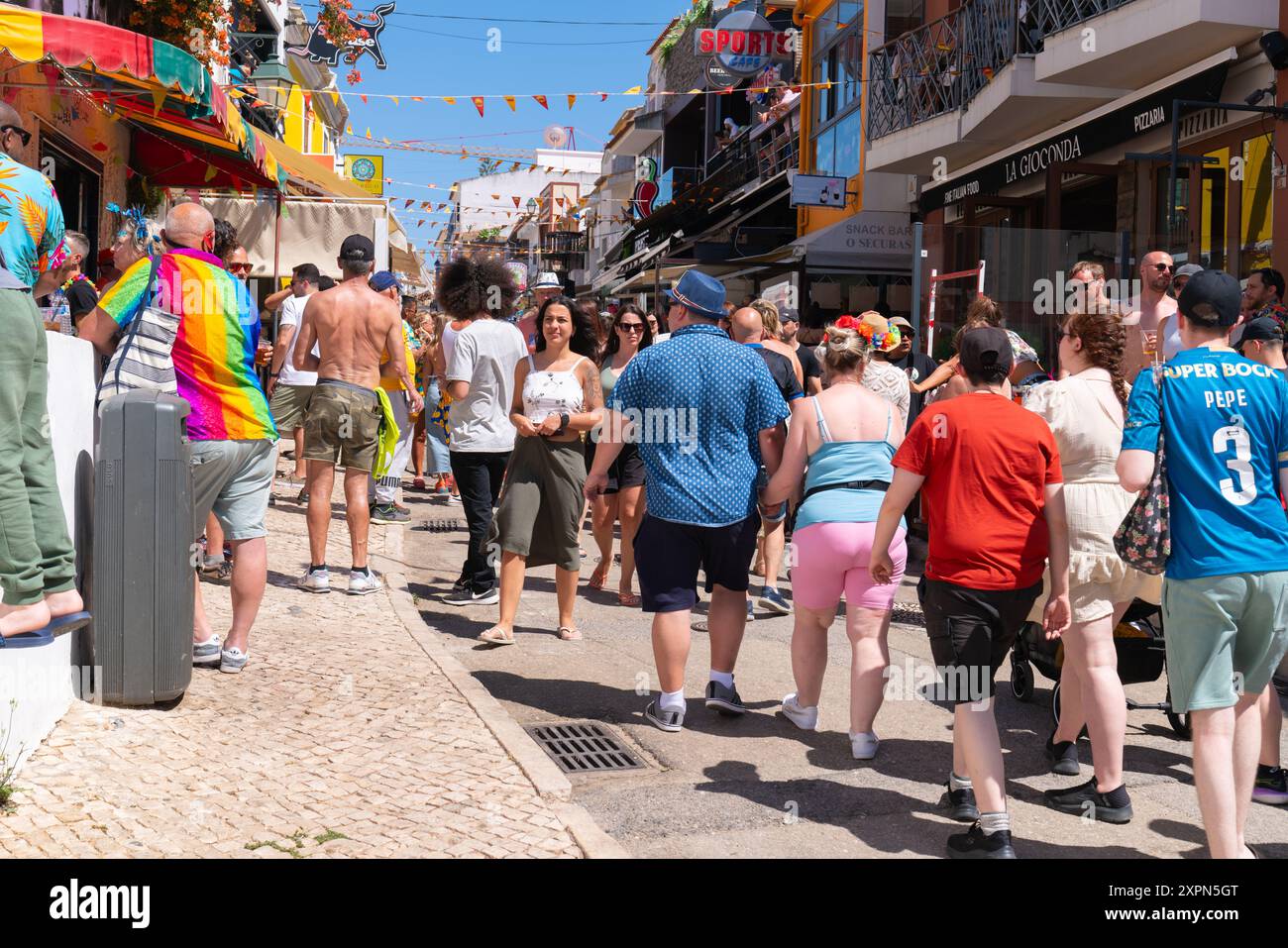 Alvor Portugal street with people in Algarve town with tourists and ...
