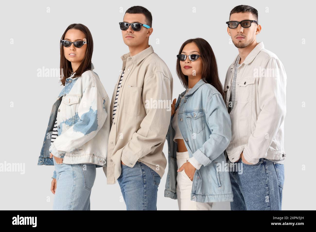 Group of young people in stylish denim clothes on white background ...
