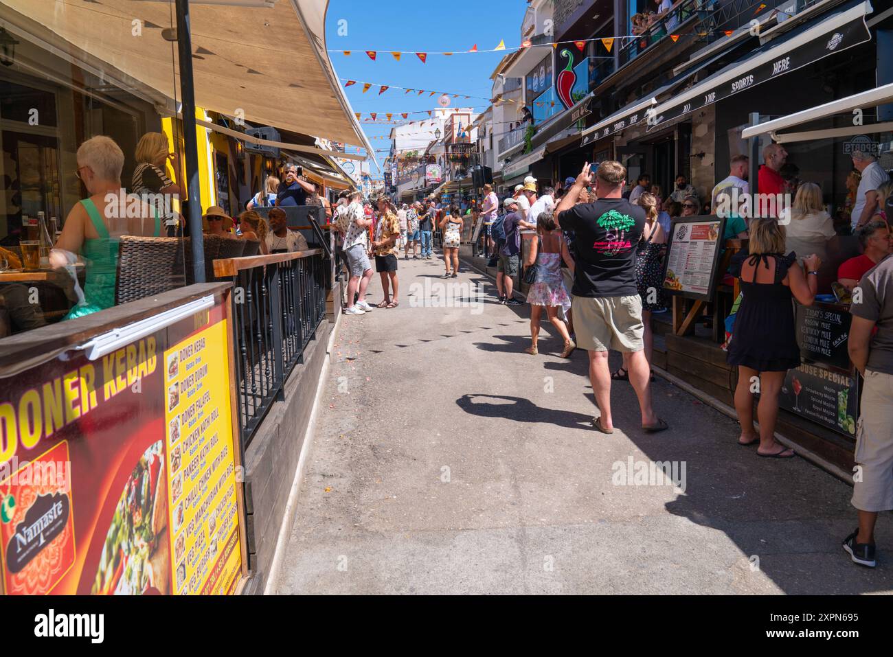 Alvor Portugal busy street in Algarve town with tourists and visitors ...