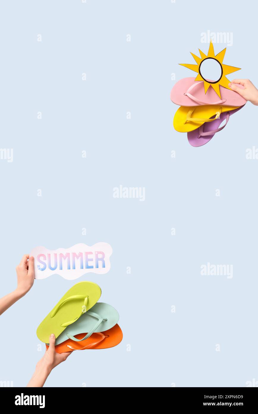Hands holding flip flops with paper sun and paper with word SUMMER on ...