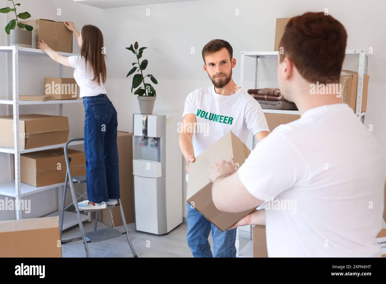 Woman volunteering in donation center hi-res stock photography and ...