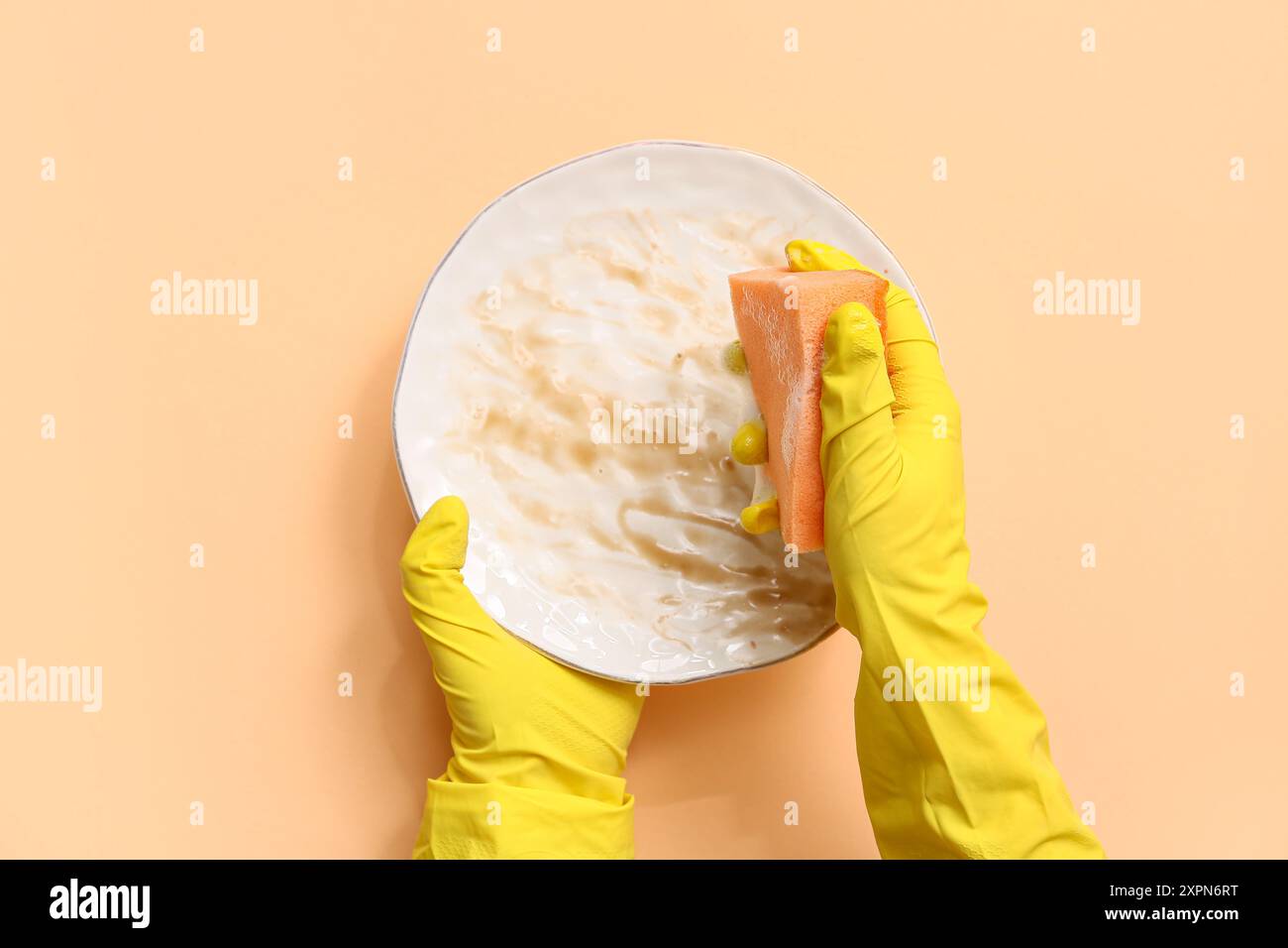 Hands washing dishes on beige background Stock Photo - Alamy