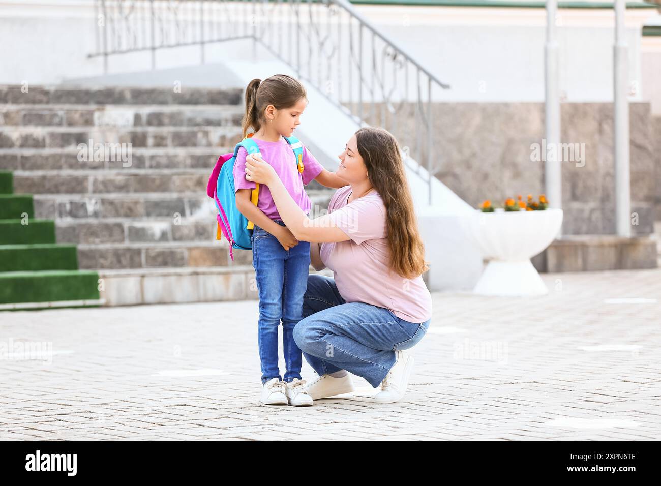 Mother saying goodbye to her little daughter near school Stock Photo ...