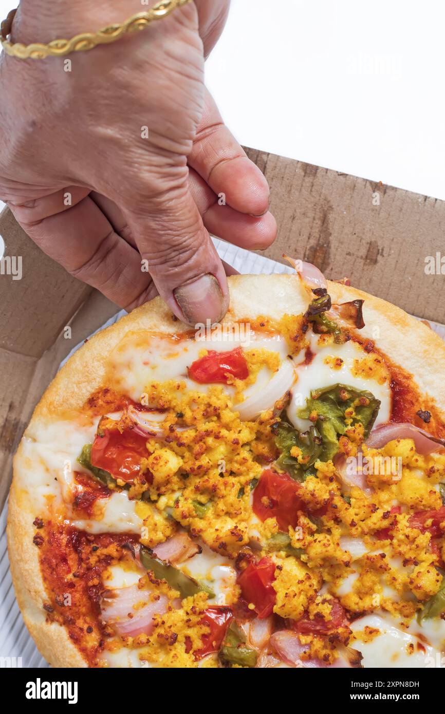 Pizza with paneer and cheese in a cardboard box with the hands of a ...
