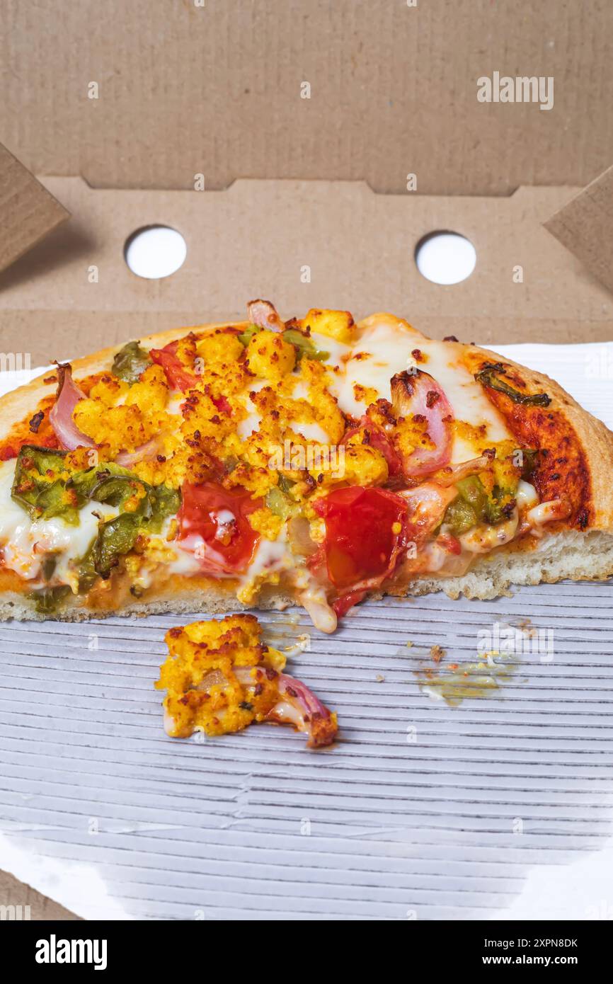 Closeup of leftover pizza in cardboard box on white background ...