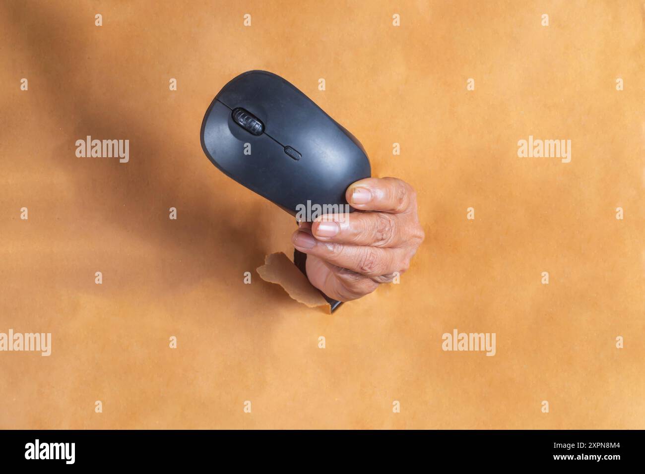 Close up of female hand holding a wireless mouse comes out tearing the ...