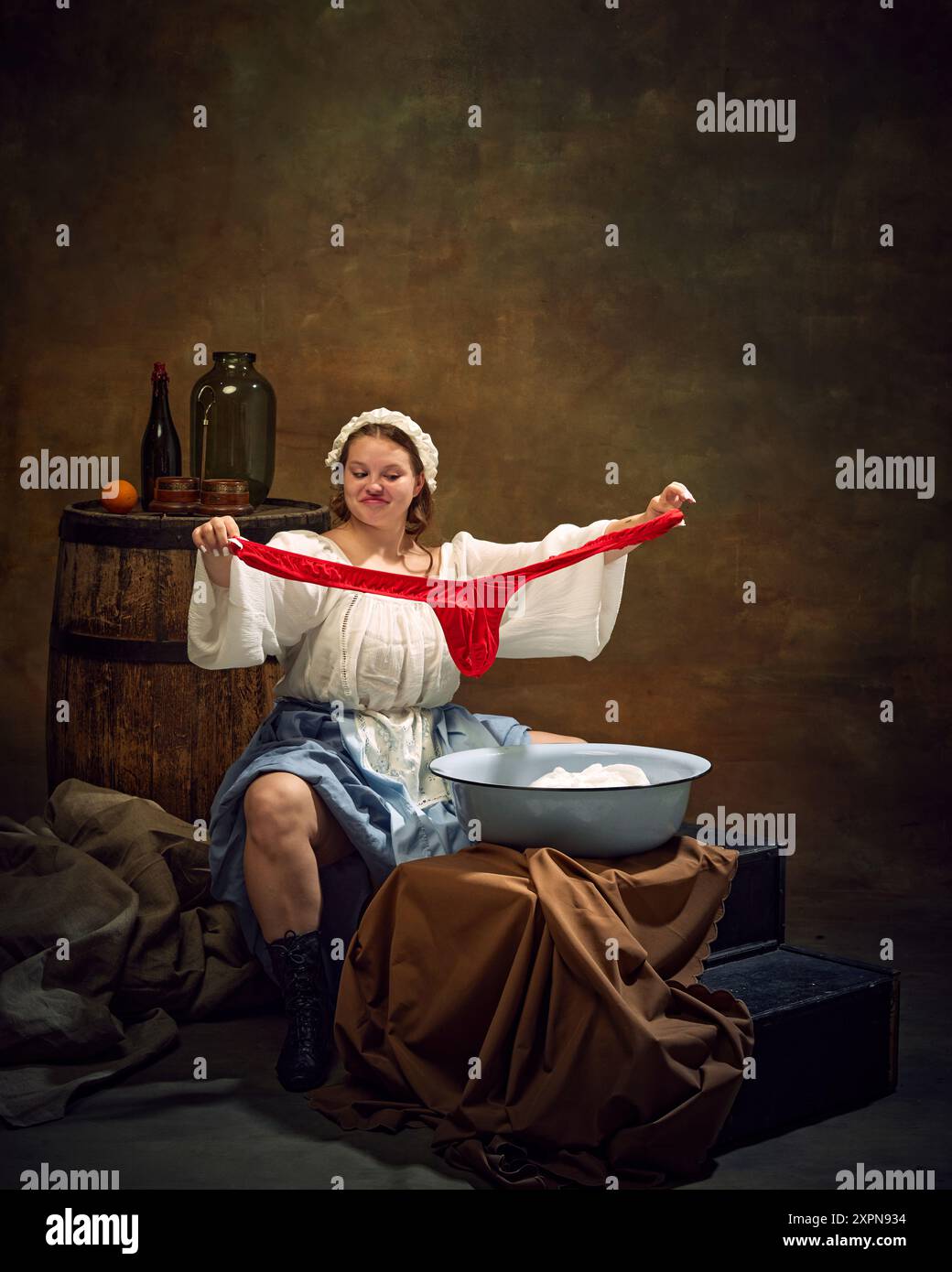 Young chubby medieval woman washing clothes. Lady in old-fashion ...