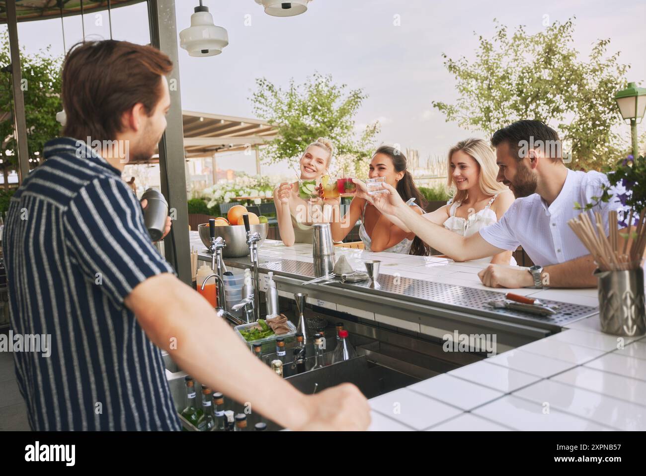 Young people, friends meeting in modern bar, open air restaurant ...