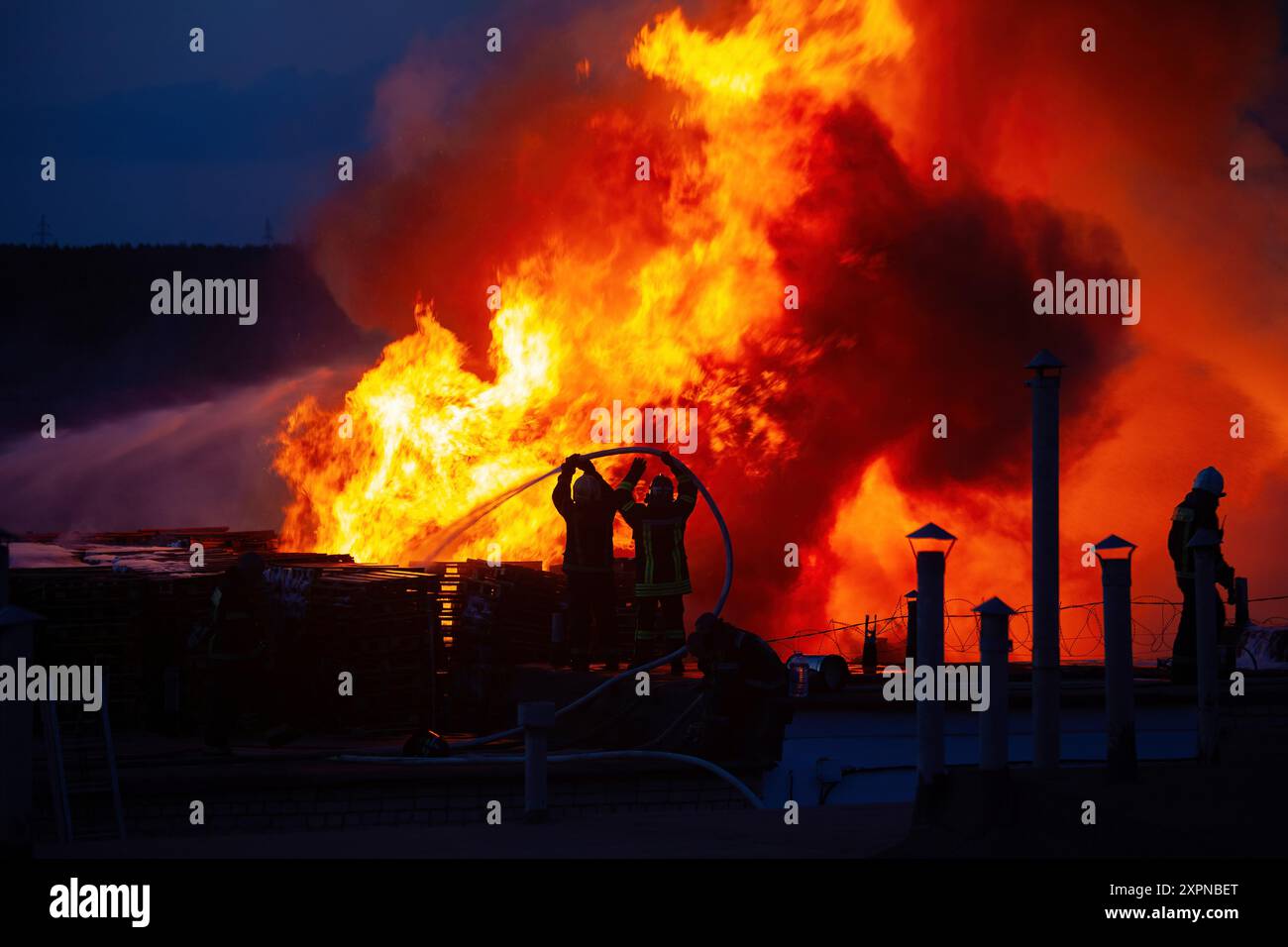 Fireman in helmet extinguish flame hi-res stock photography and images ...