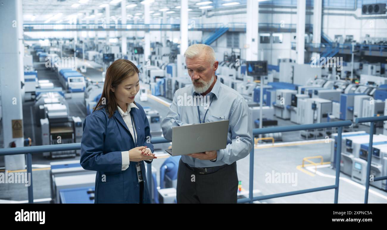 Experienced Middle Aged Engineer Giving an Electronics Factory Tour to ...