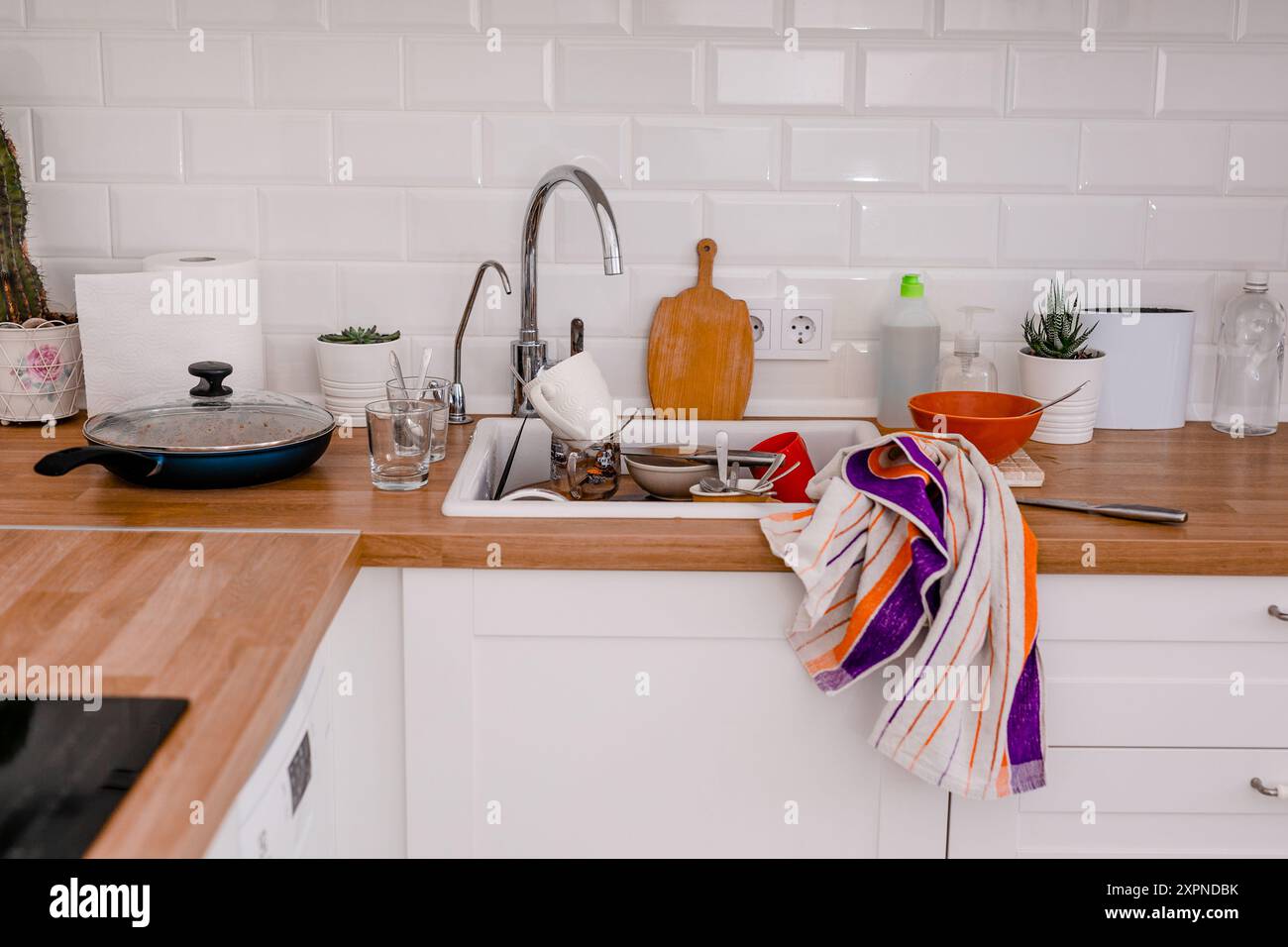 Clutter, dirty dishes by the sink in the white kitchen Stock Photo - Alamy
