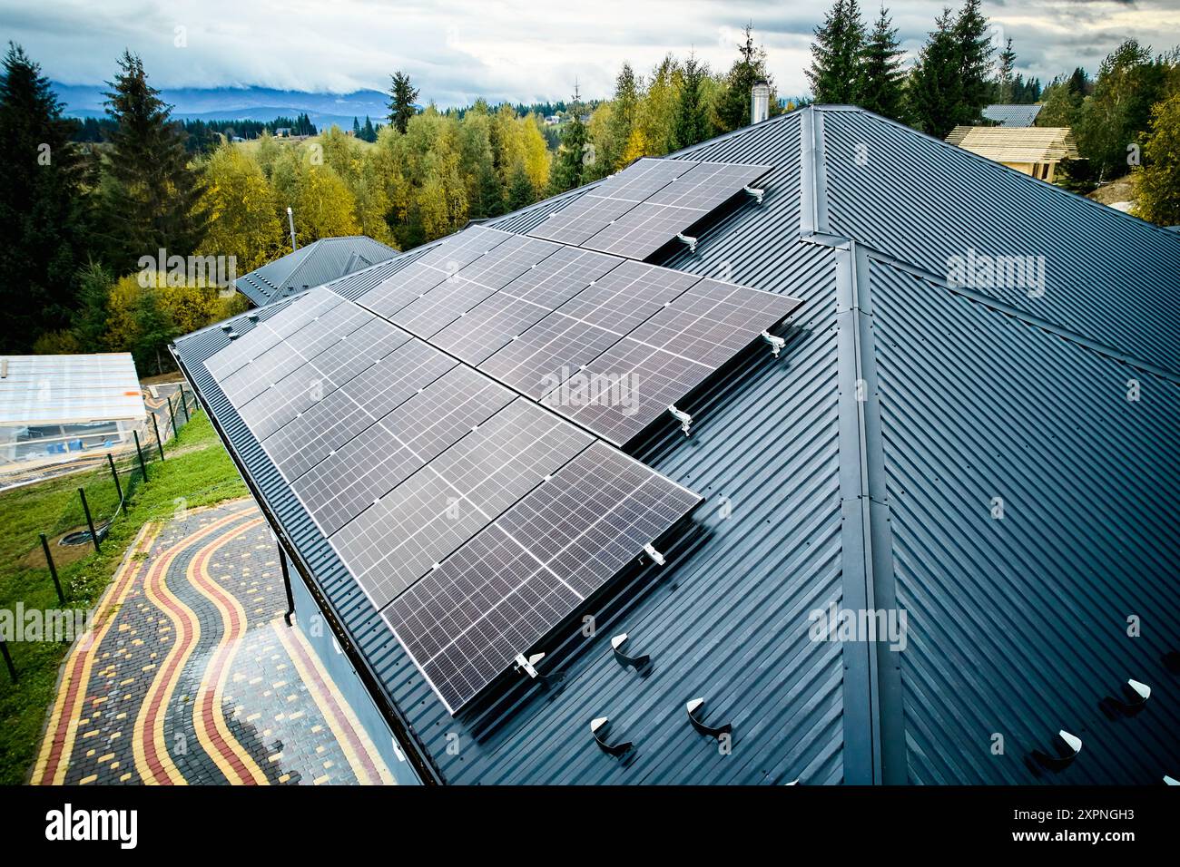 Aerial view of new modern house cottage with solar photovoltaic panel ...