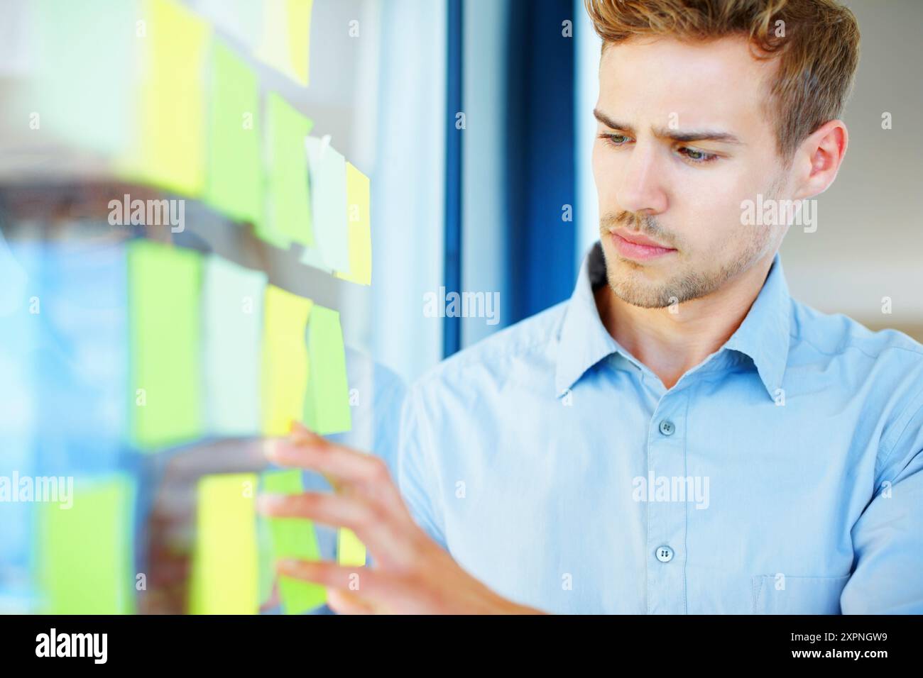Man, office and sticky notes for brainstorming idea, glass wall and ...
