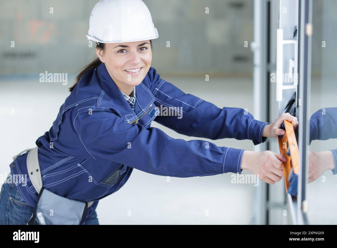 woman builder measuring wall by water level instrument Stock Photo - Alamy