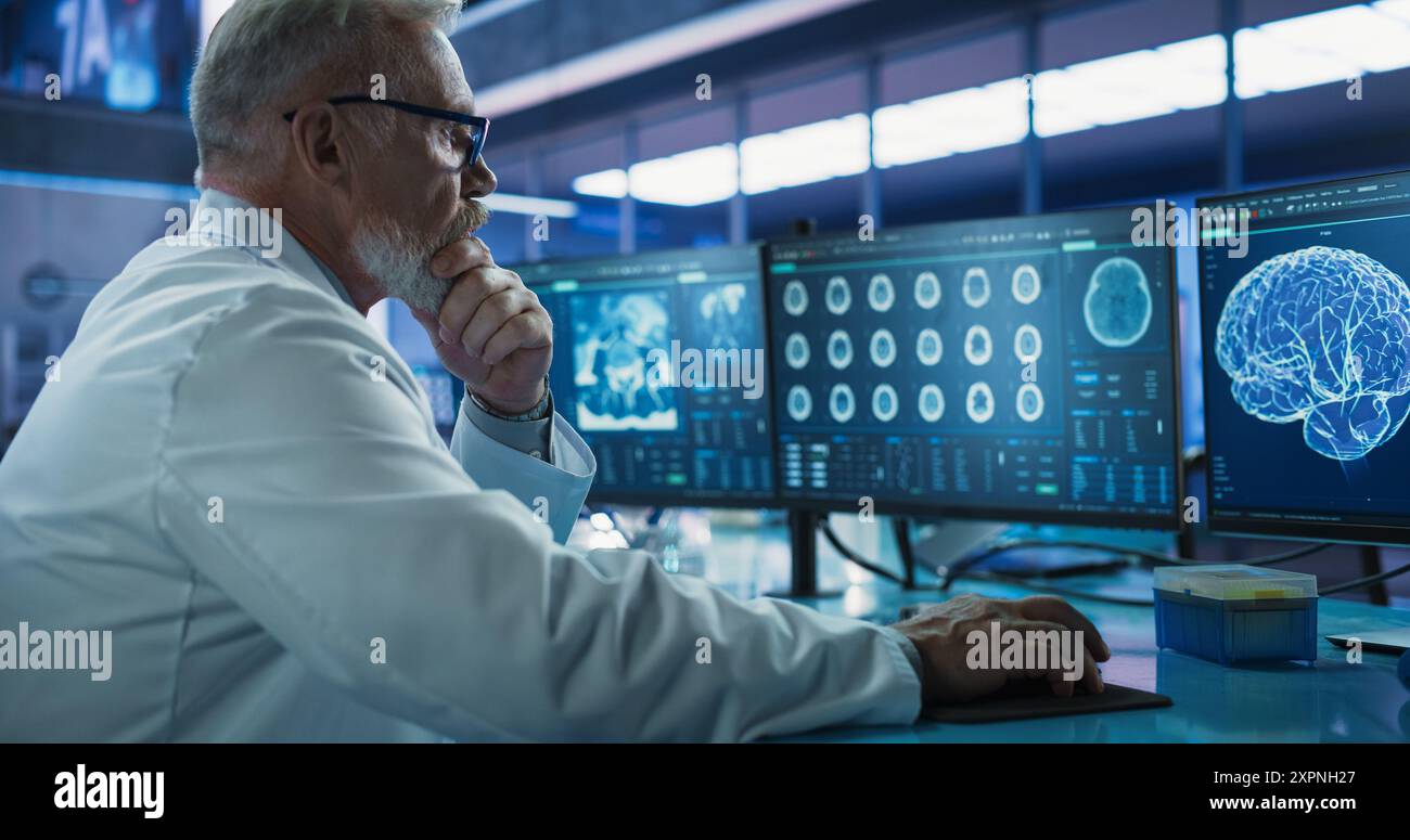 Senior Male Neuroscientist Using Desktop Computer To Analyze MRI Scans ...