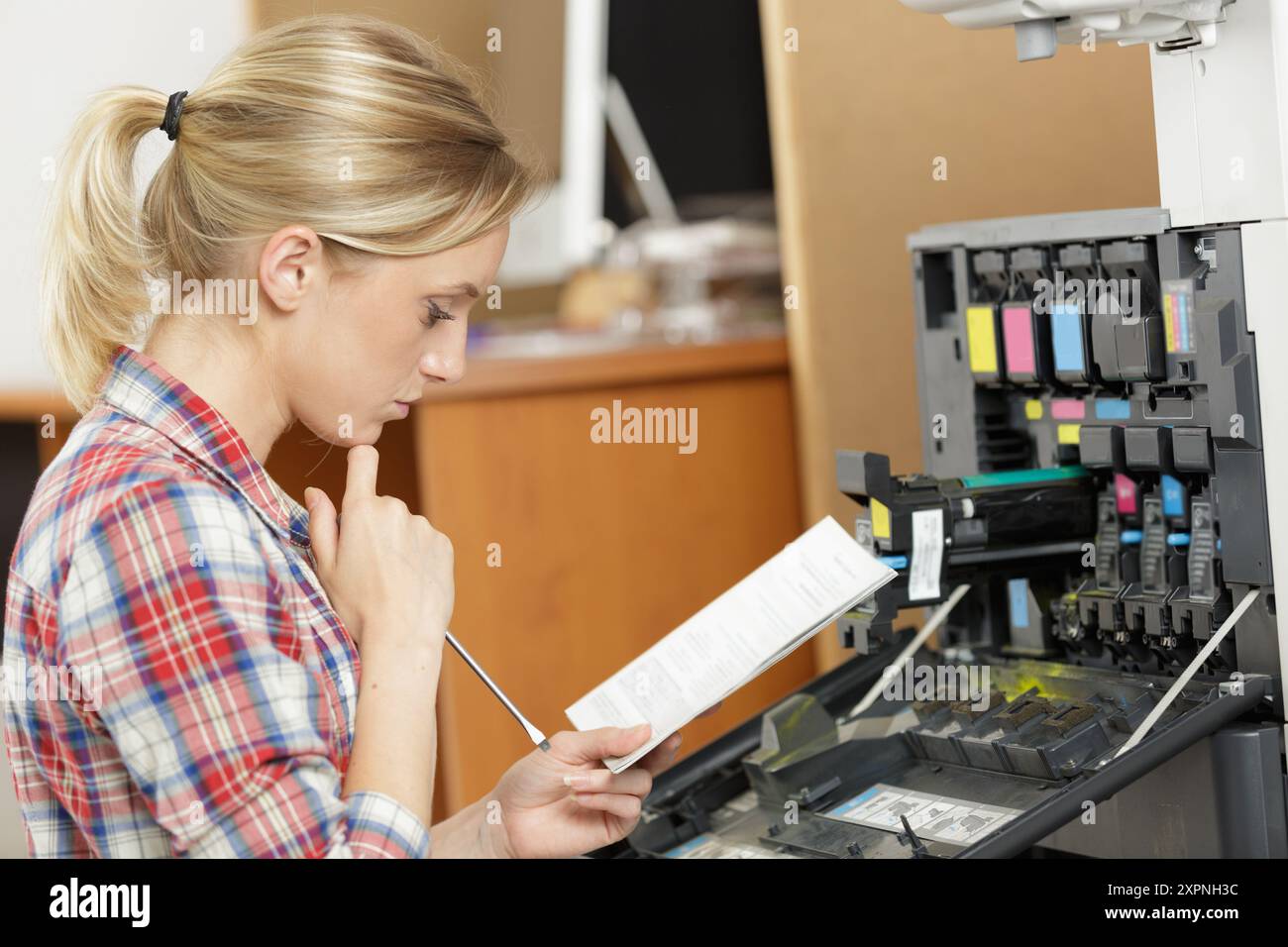Female technician checking printer hi-res stock photography and images ...