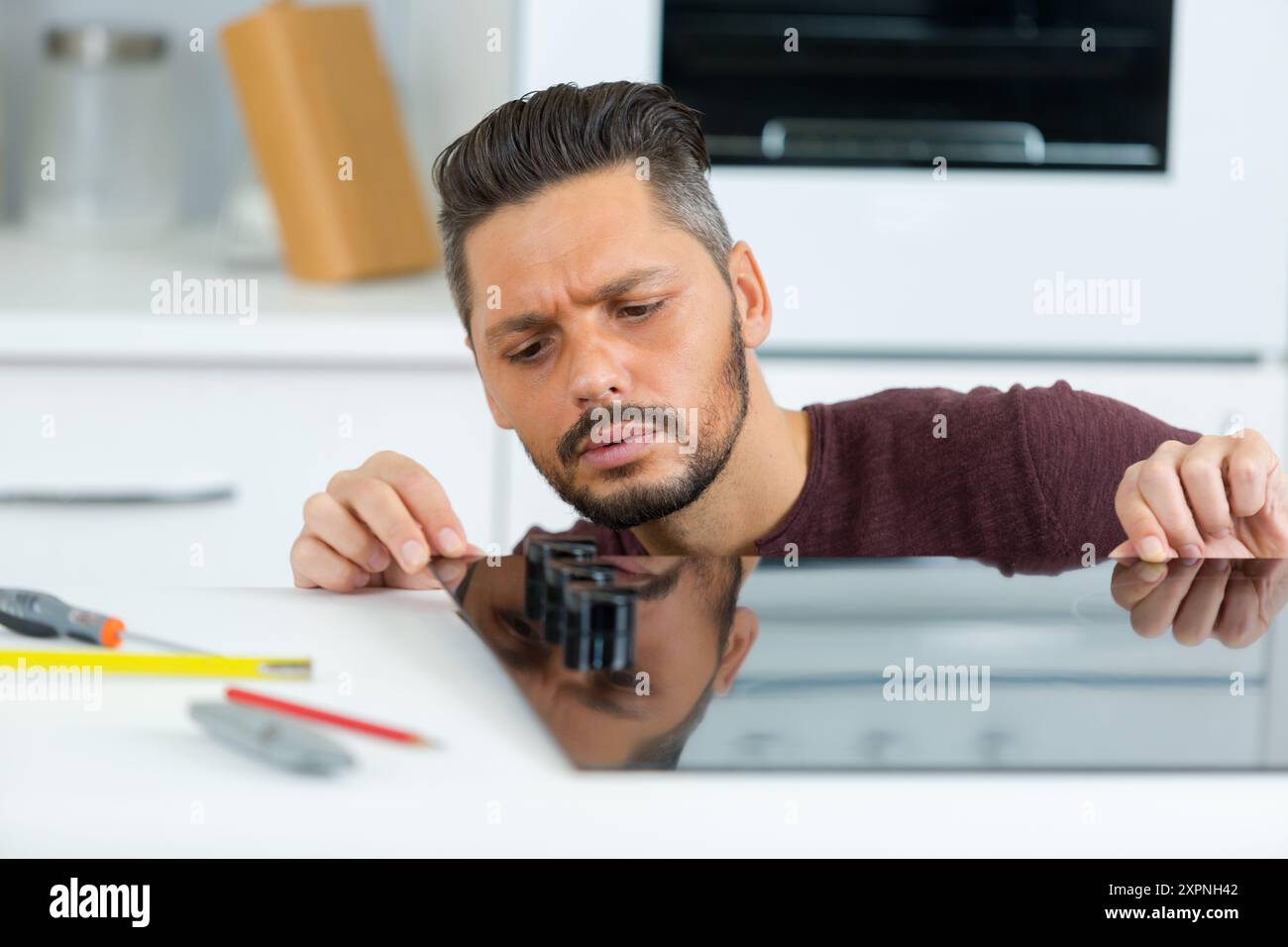 Happy handyman fixing door hi-res stock photography and images - Alamy