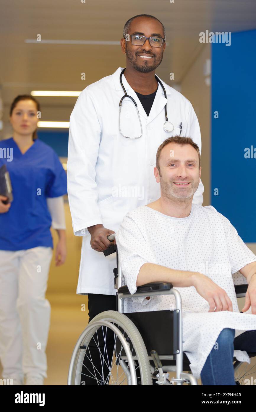 male medical doctor pushing patient on wheelchair Stock Photo - Alamy