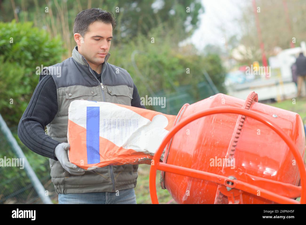 man making cement with a concrete machine Stock Photo - Alamy