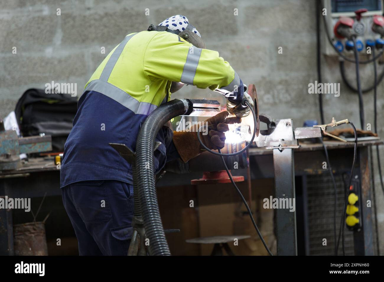 man soldering metal in a factory Stock Photo - Alamy