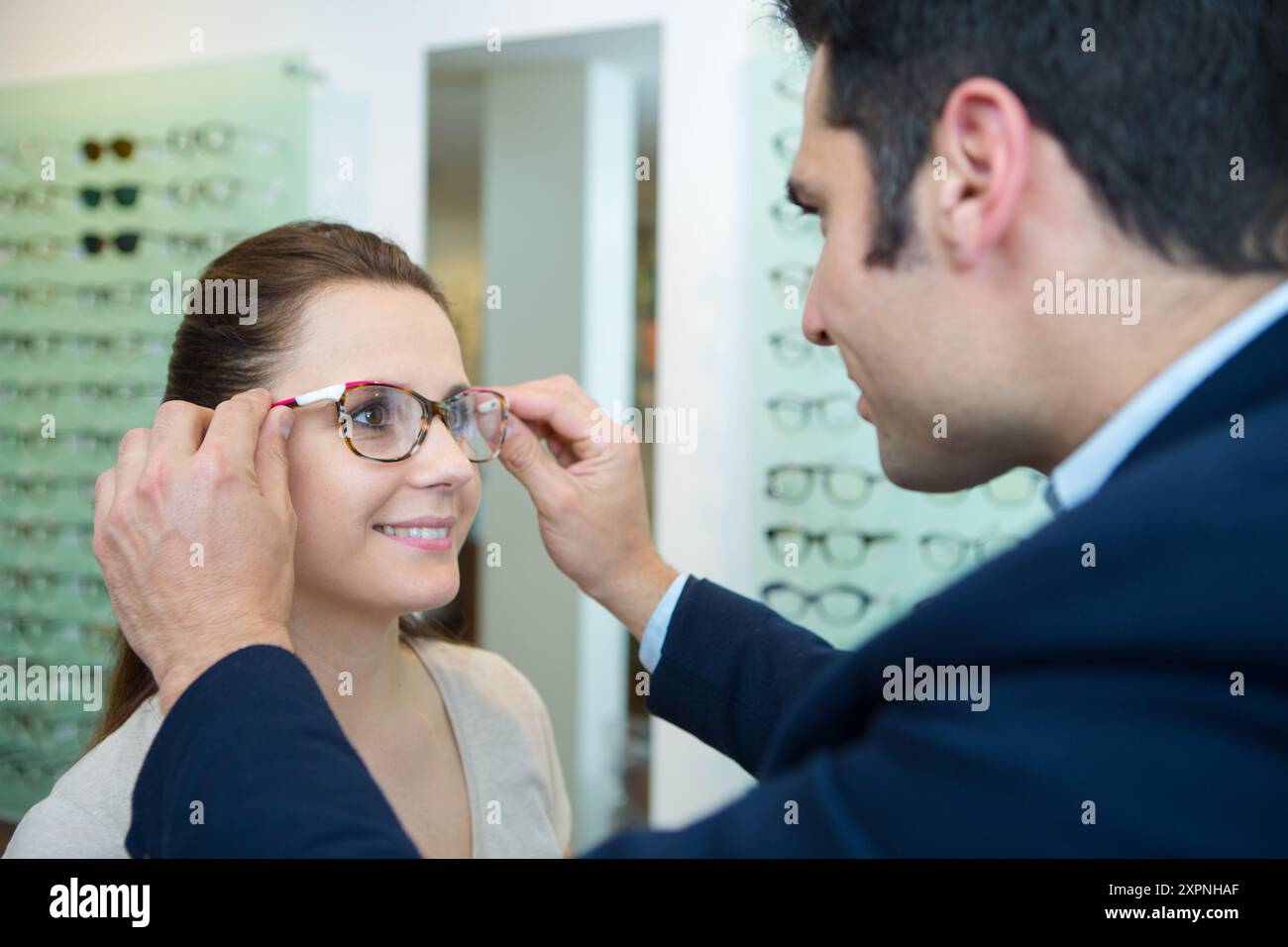Female optometrist helping patient hi-res stock photography and images ...