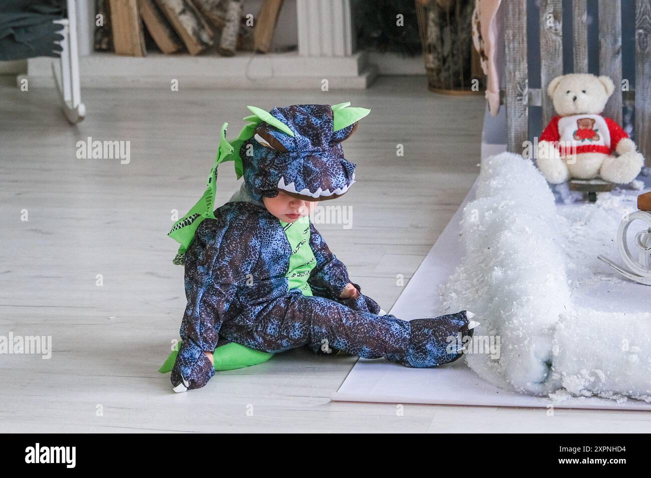 A cute baby character in a dragon costume sits in an egg shell Stock ...