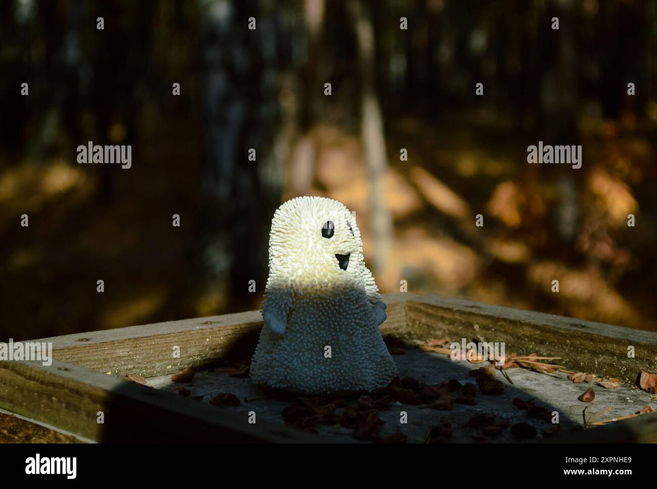 A shadow falls on a toy ghost standing sideways Stock Photo - Alamy
