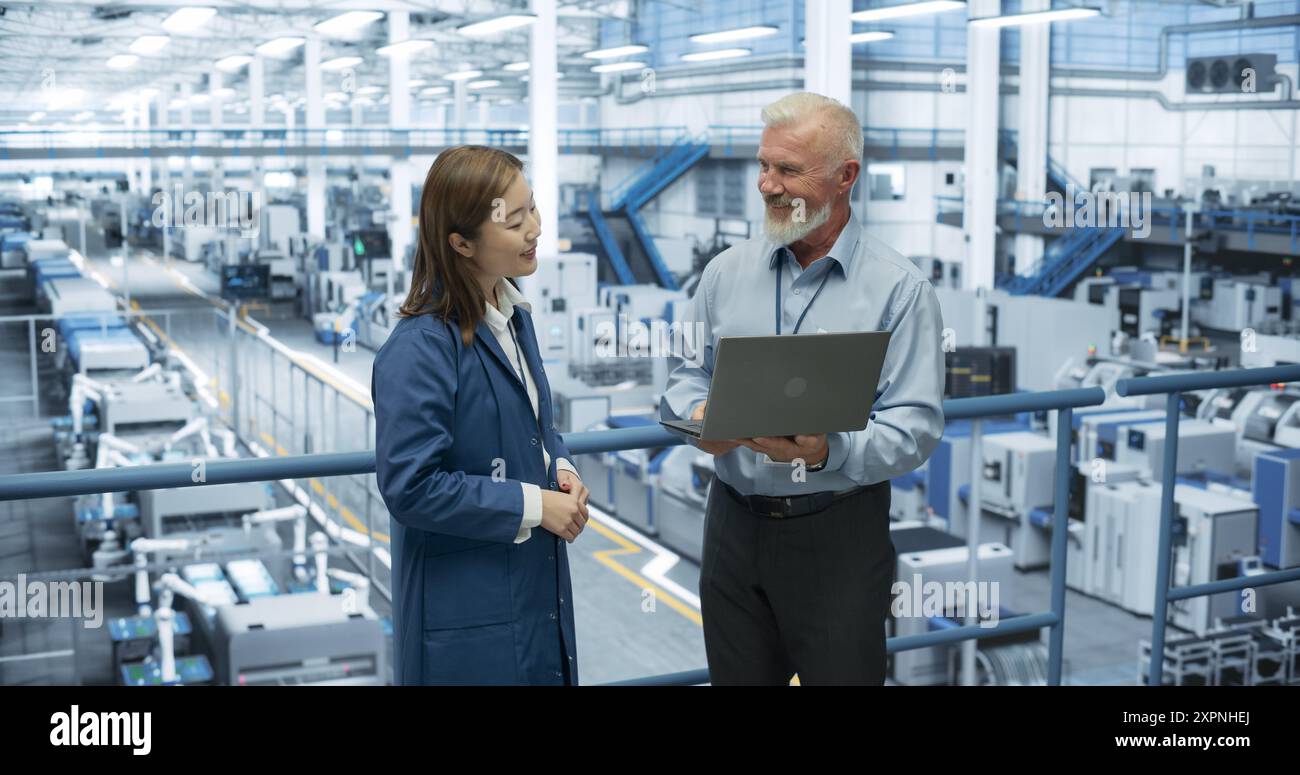 Experienced Middle Aged Engineer Giving an Electronics Factory Tour to ...