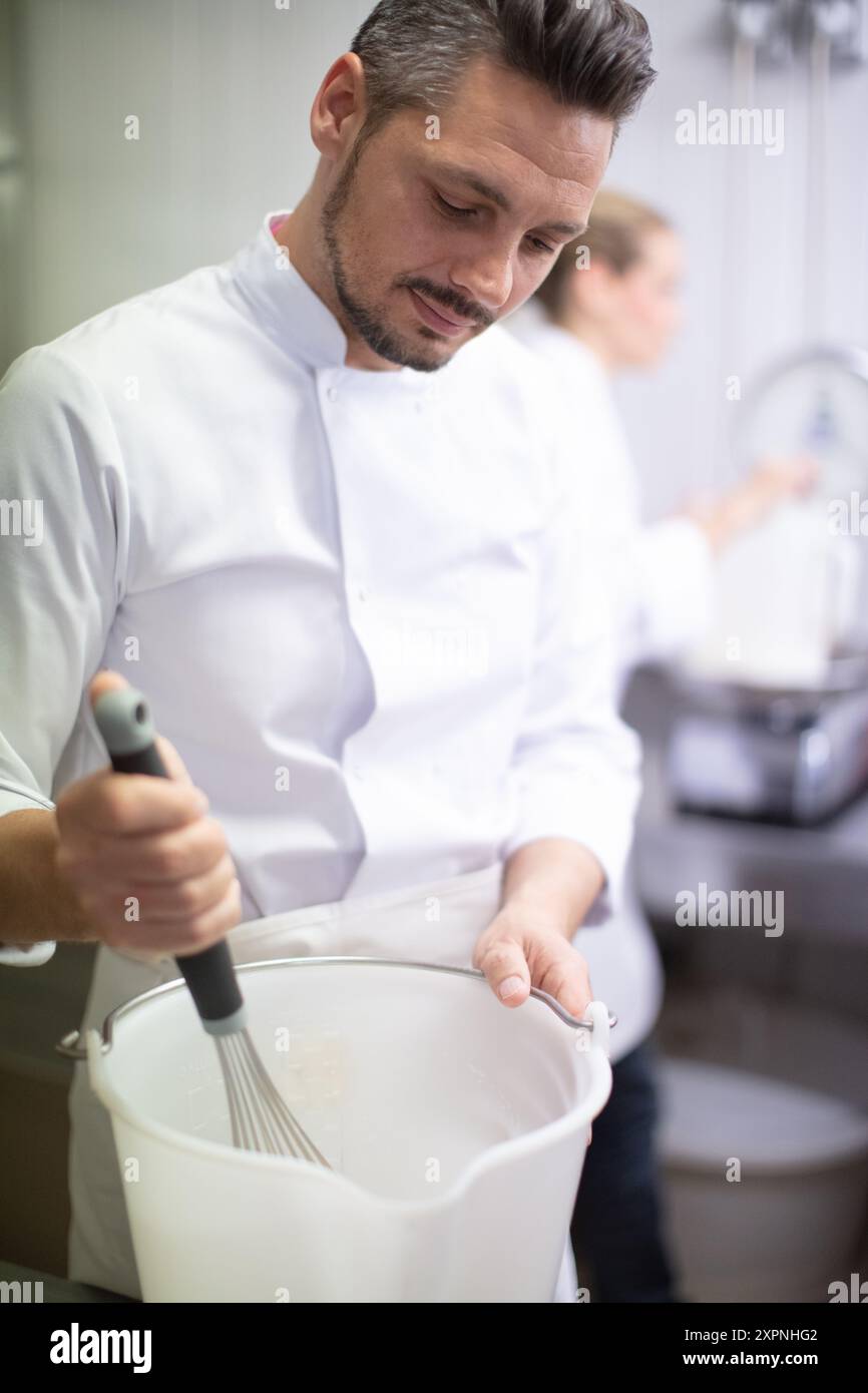 Baker chef whisking melted hi-res stock photography and images - Alamy
