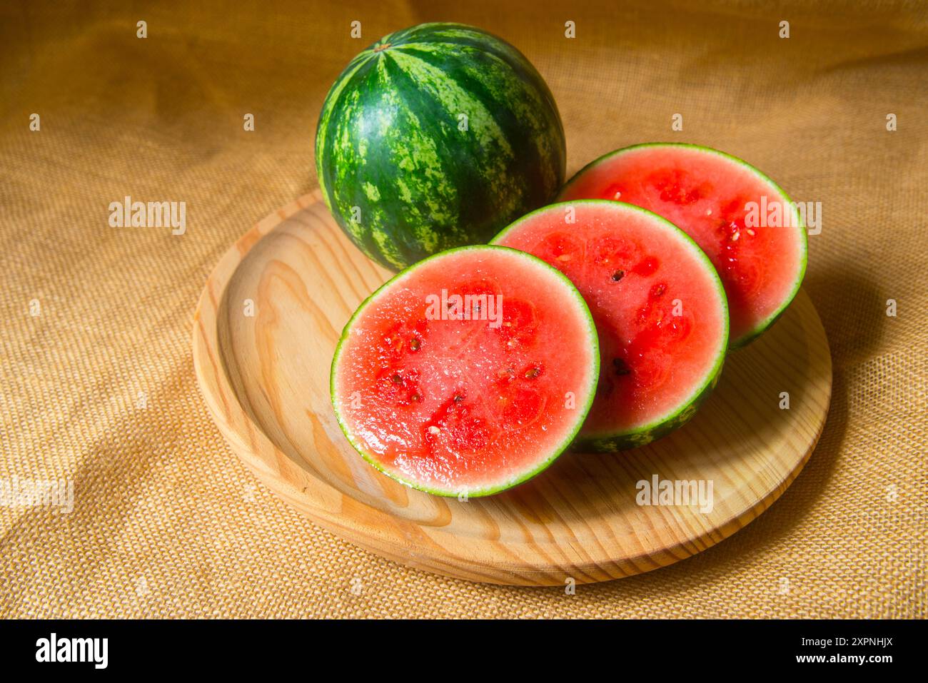 Two watermelons, one of them cut in slices. Still life Stock Photo - Alamy
