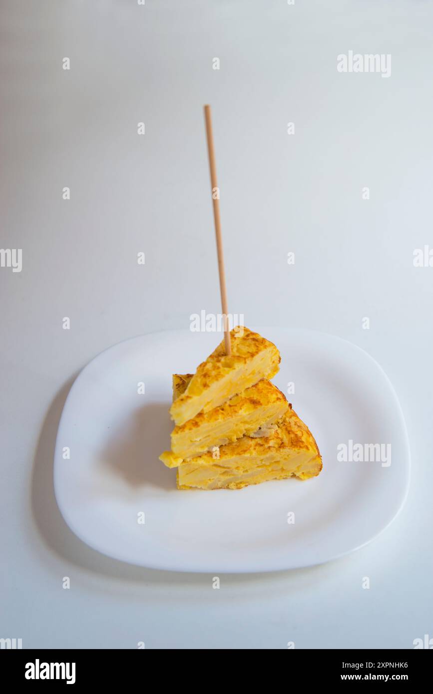 Three stacked pieces of Spanish omelet Stock Photo - Alamy
