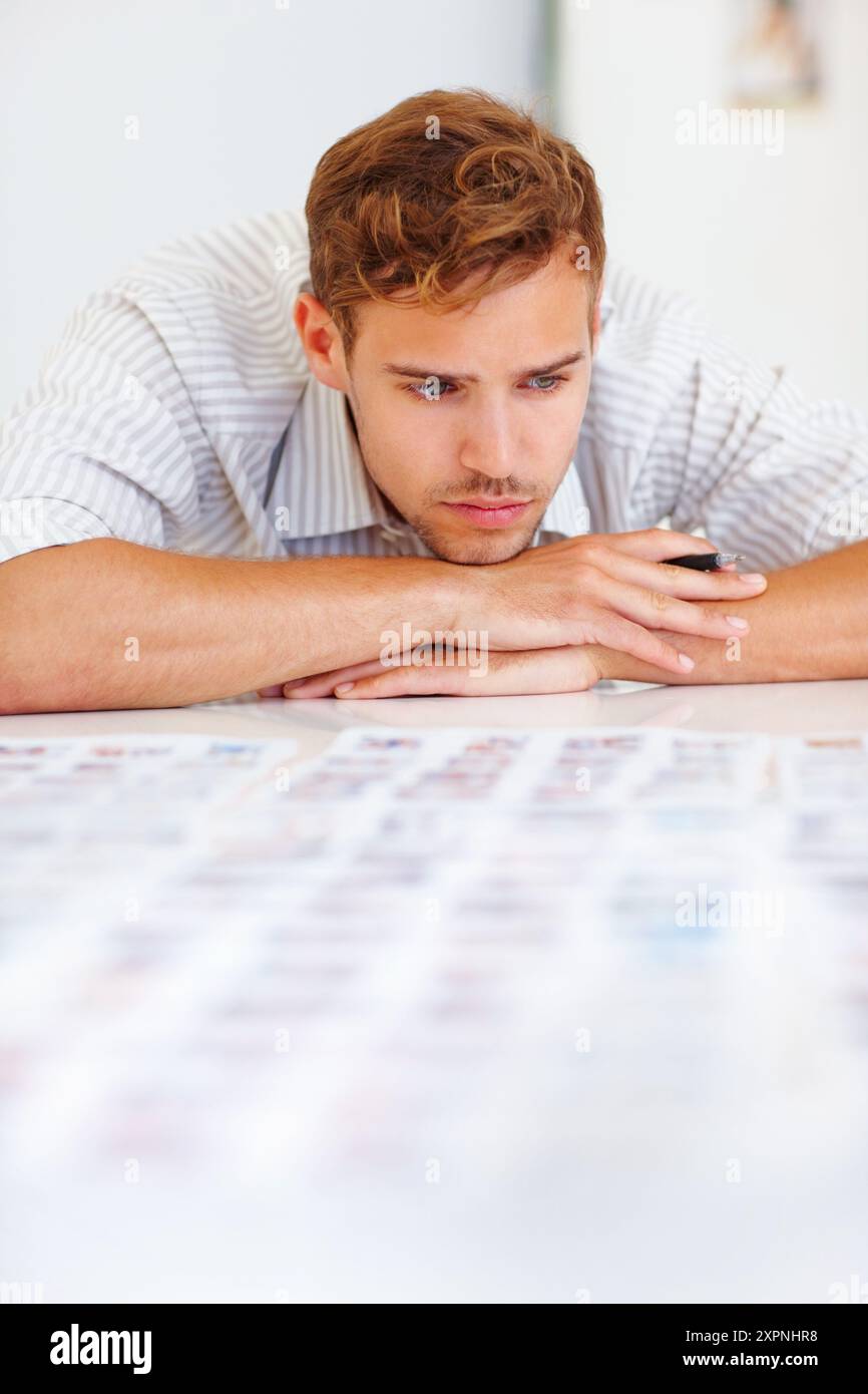 Thinking, choice and picture on table, man and analysis of photographs ...