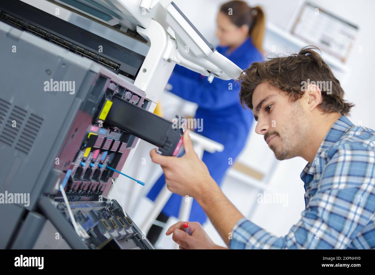 a man fixing a printer Stock Photo - Alamy