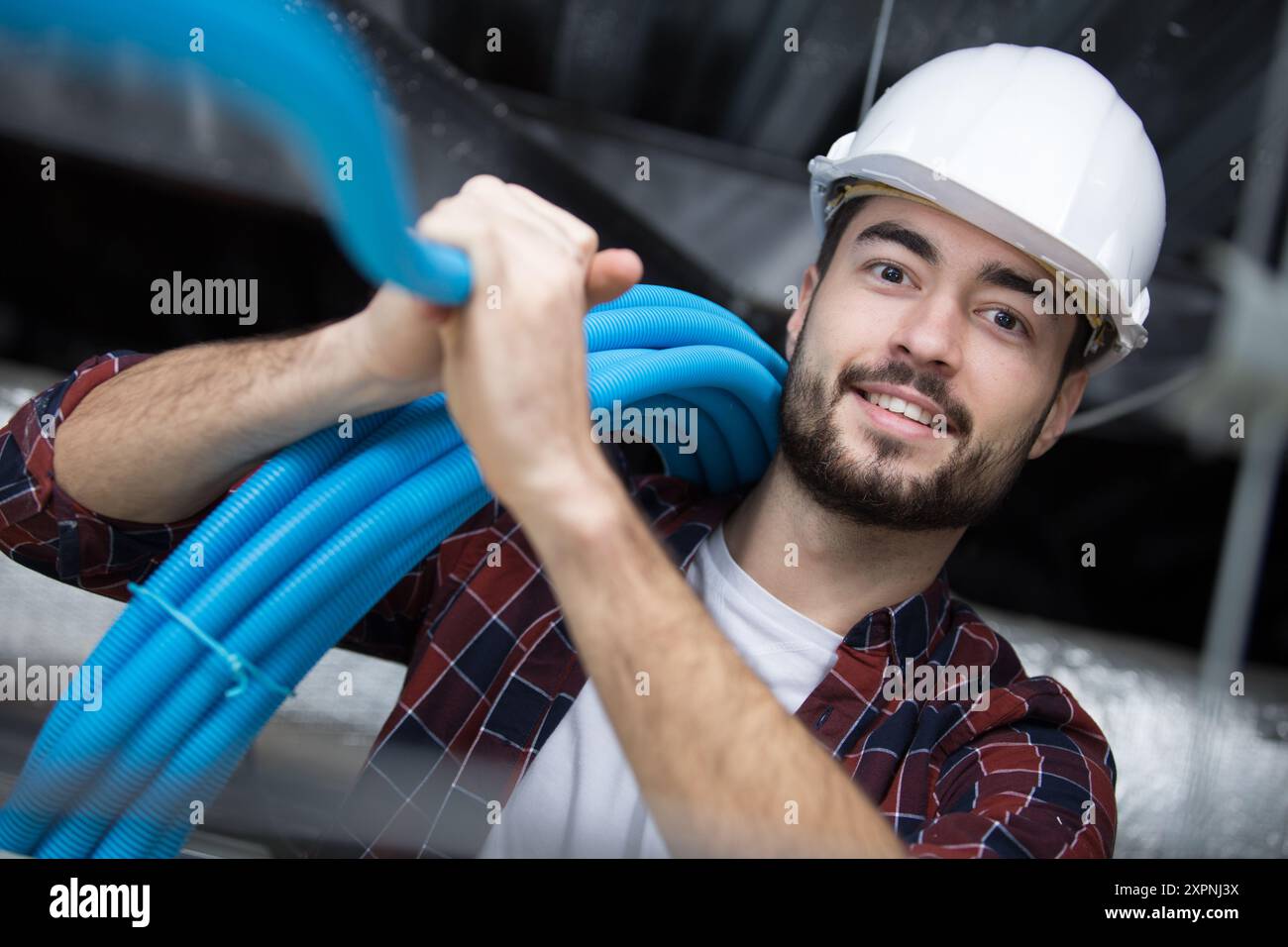 portrait of young man working in construction site with pipes Stock ...
