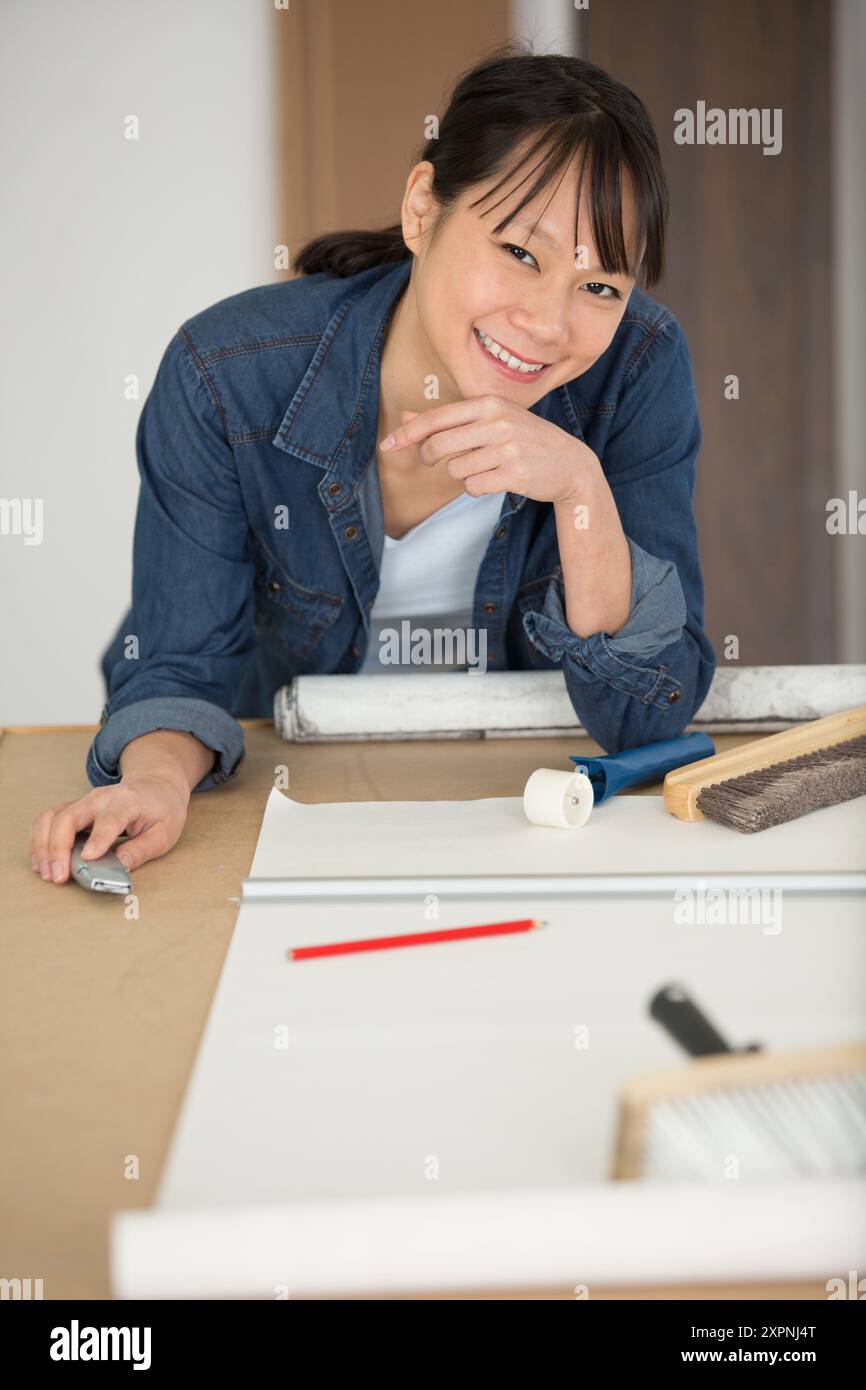 happy woman preparing for wallpaper work Stock Photo - Alamy