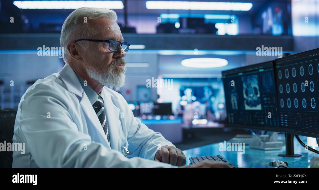 Senior Male Neuroscientist Using Desktop Computer To Analyze MRI Scans ...
