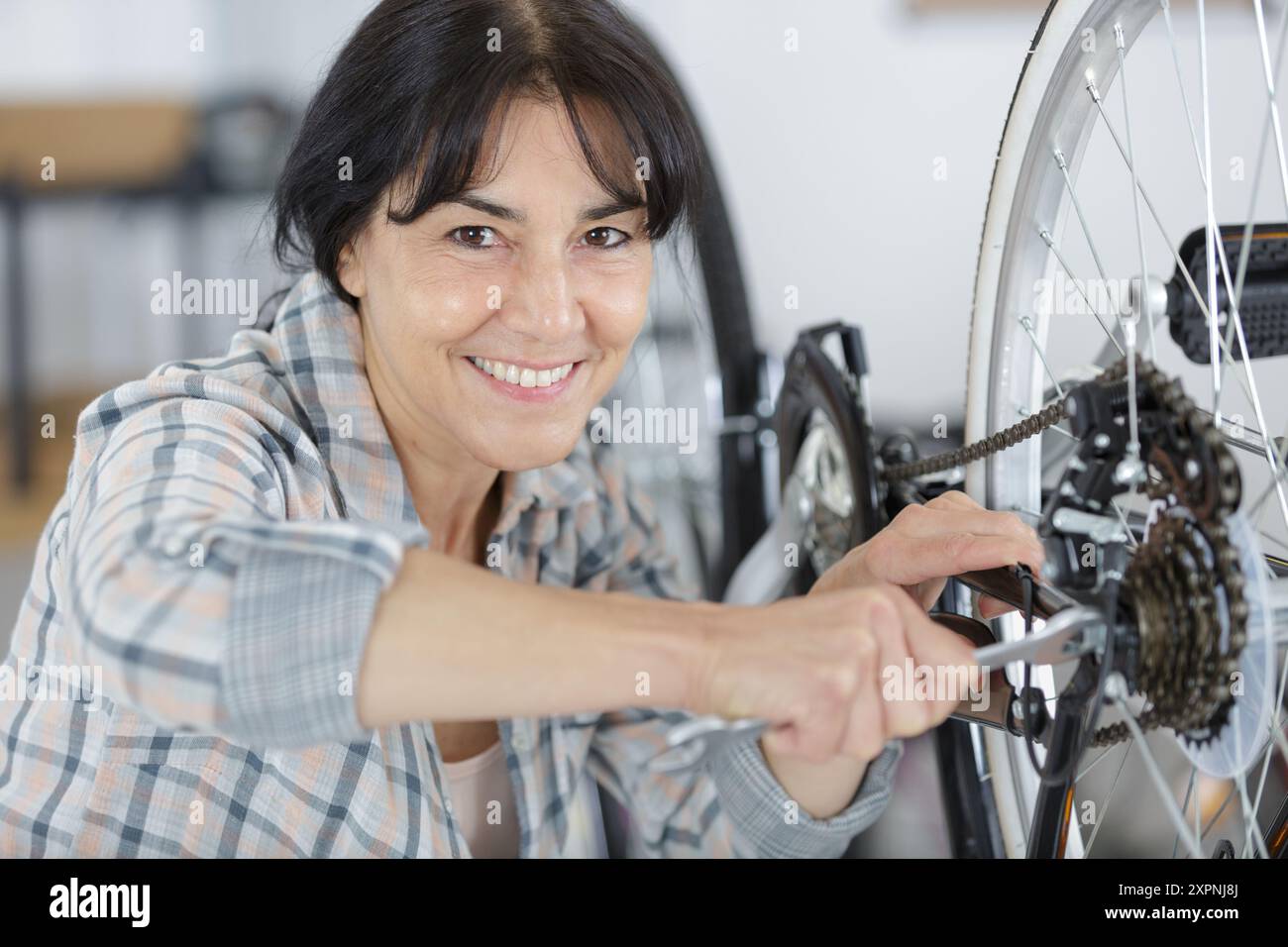 woman mature taking care of her bike Stock Photo - Alamy