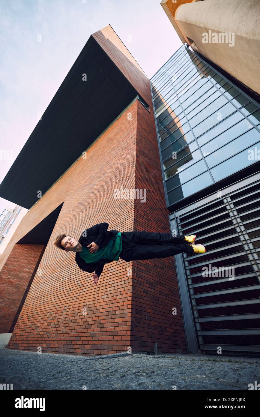 Breakdancer in green shirt and orange bucket hat performs impressive ...