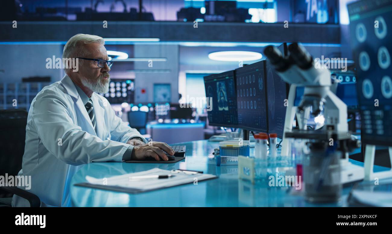 Senior Male Neuroscientist Using Desktop Computer To Analyze MRI Scans ...