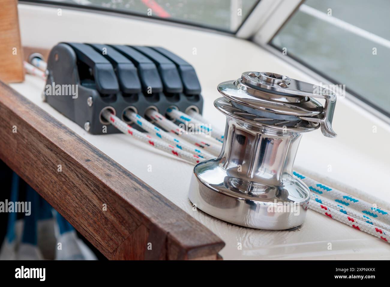 Sailboat winch on a sailing boat and ropes at stoppers, line jammer ...