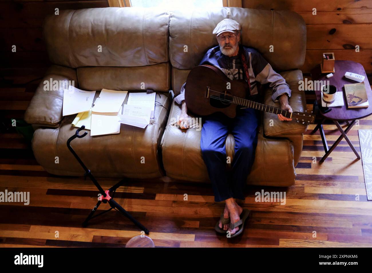 The Rev. Ron Blakely takes a break from rehearsing with sheet music and ...