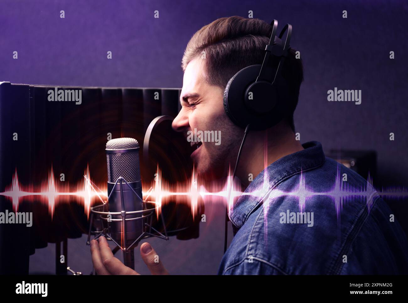 Young singer with microphone recording song in studio. Audio waveform ...