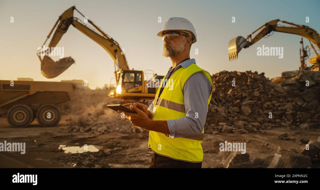 Caucasian Male Civil Engineer Wearing Protective Goggles And Using Tablet On Construction Site ...