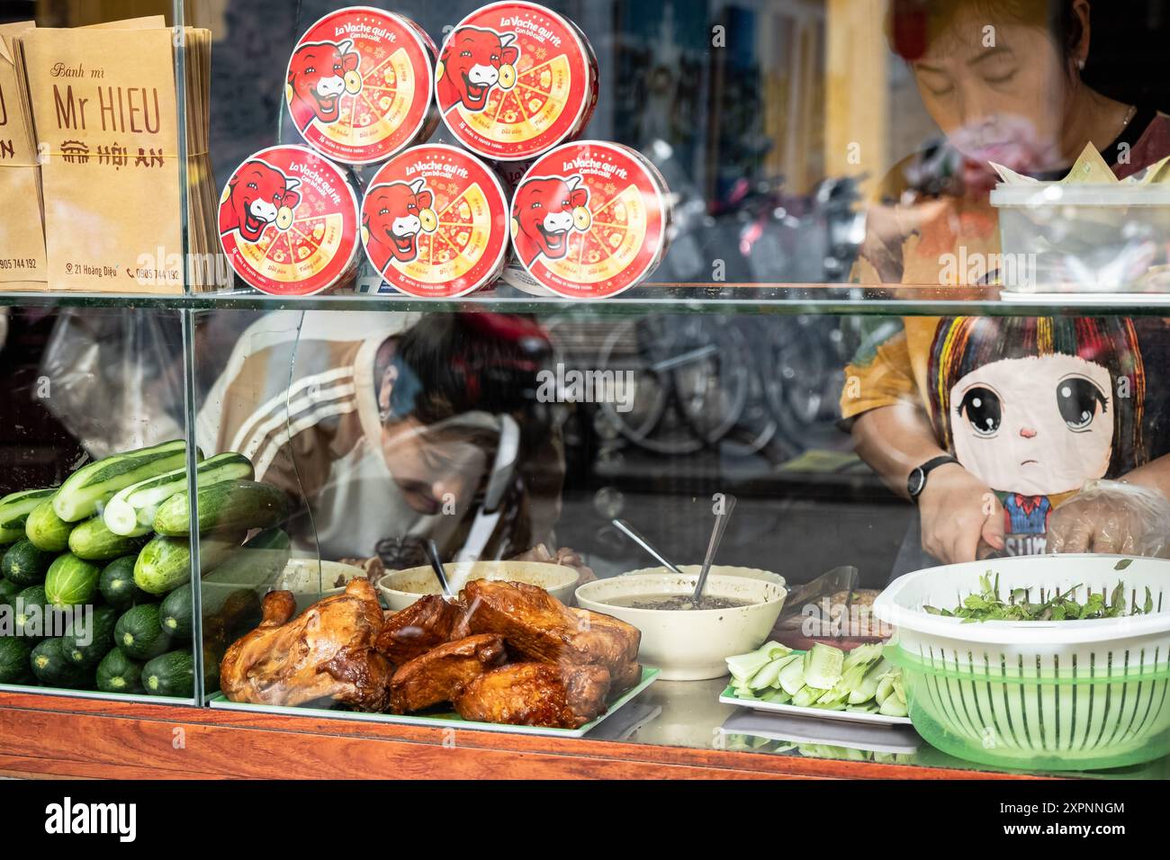 Street food chef cooking in a vendor on a street market in Hoi An ...