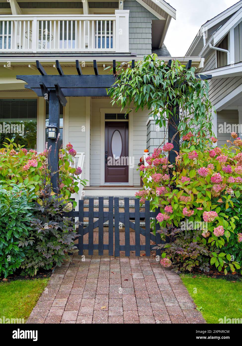 Entrance of luxury residential house with unpainted wooden gate in ...